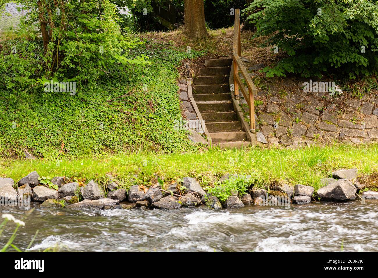 Stone stairs above the river. Recreational areas. Wooden balustrades ...