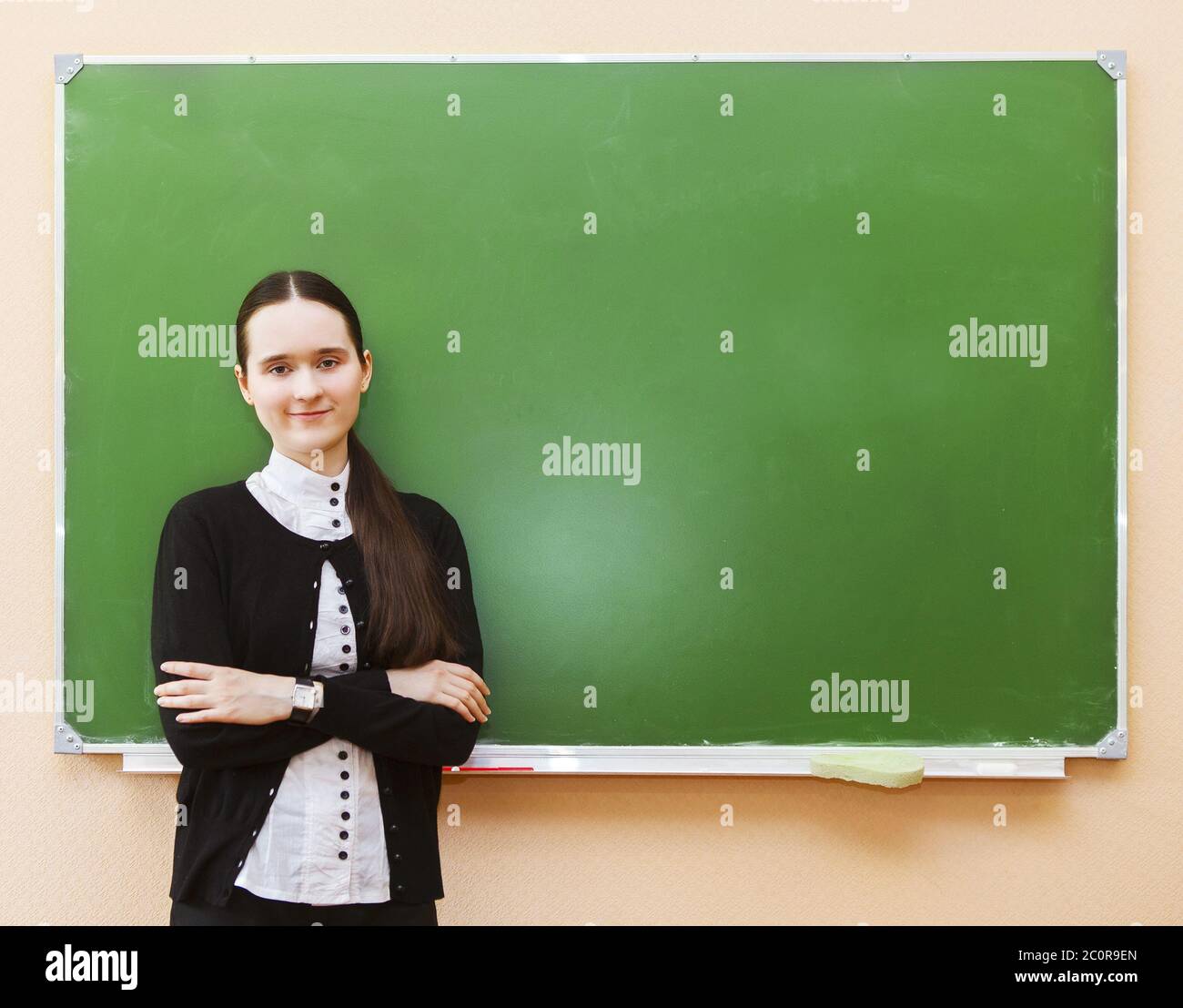 Student girl standing near clean blackboard in the classroom Stock ...