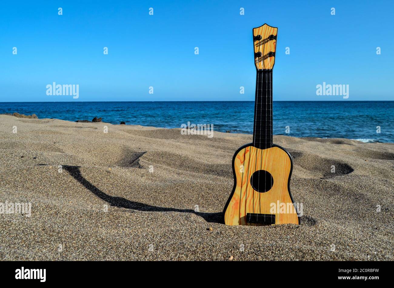 Guitar on the Sand Beach Stock Photo - Alamy