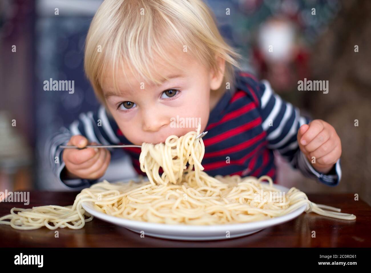 Sweet toddler child, boy, eating spaghetti at home on Christmas Stock ...