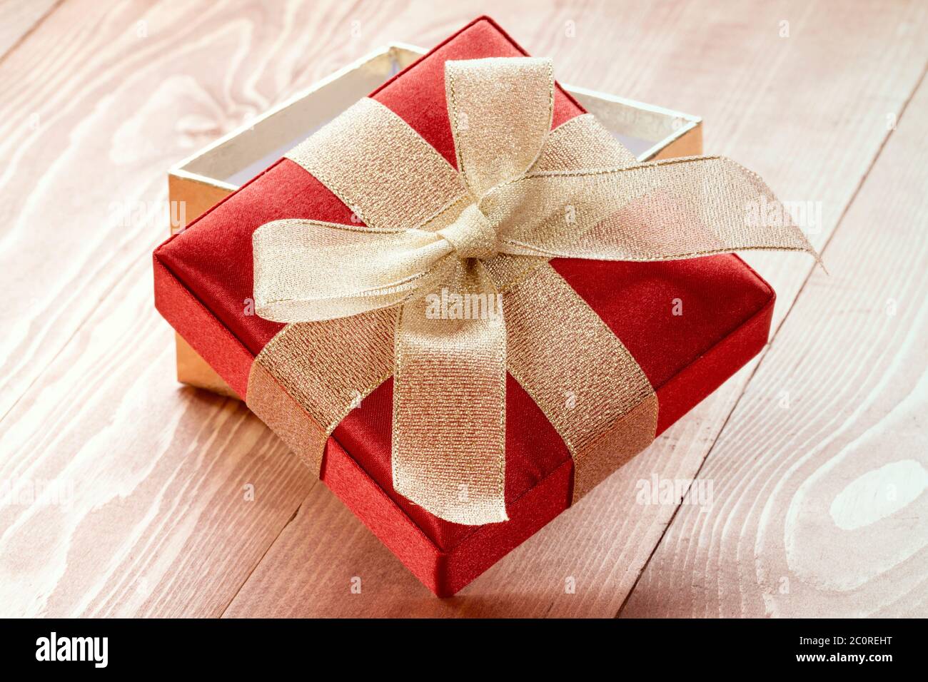 Gift box with golden ribbon and bow Stock Photo - Alamy