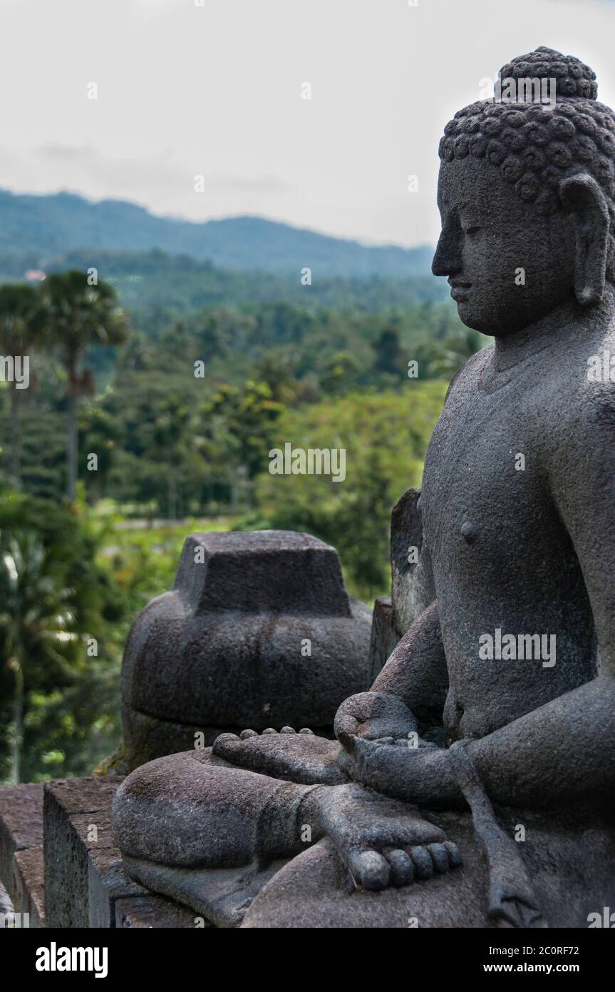 Meditating sitting Buddha sculputre in stone at Borobudur Stock Photo ...