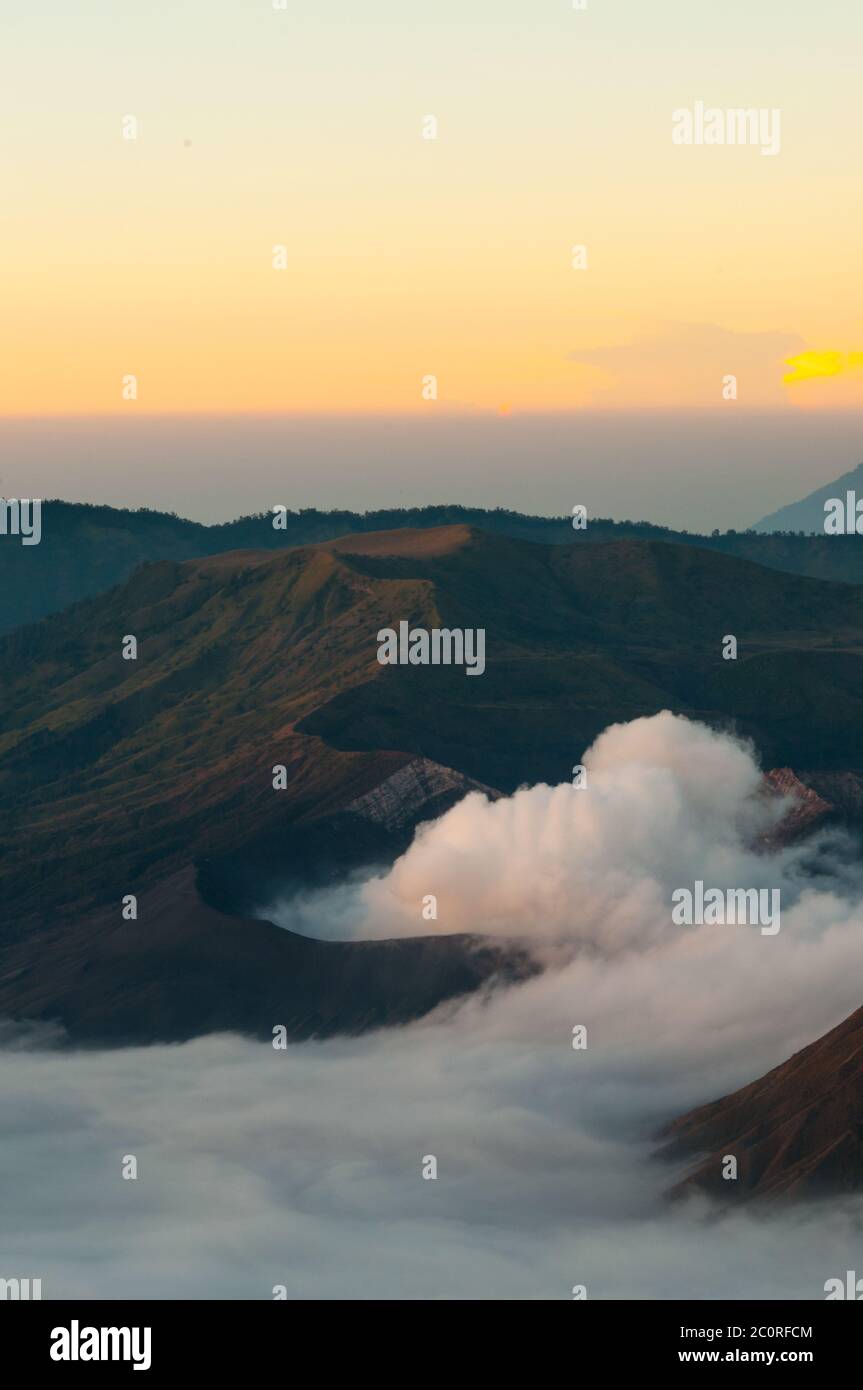 Volcano Bromo with smoke fog and mist in early morning at sunrise Stock ...