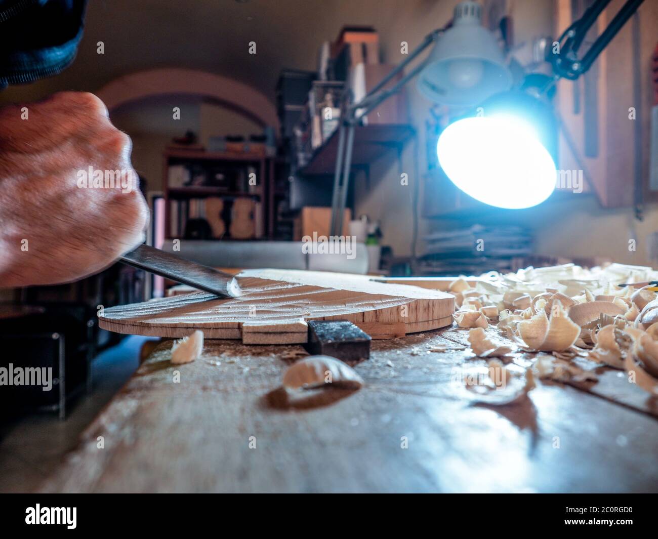 Professional luthier violinmaker artisan working on making a handmade ...