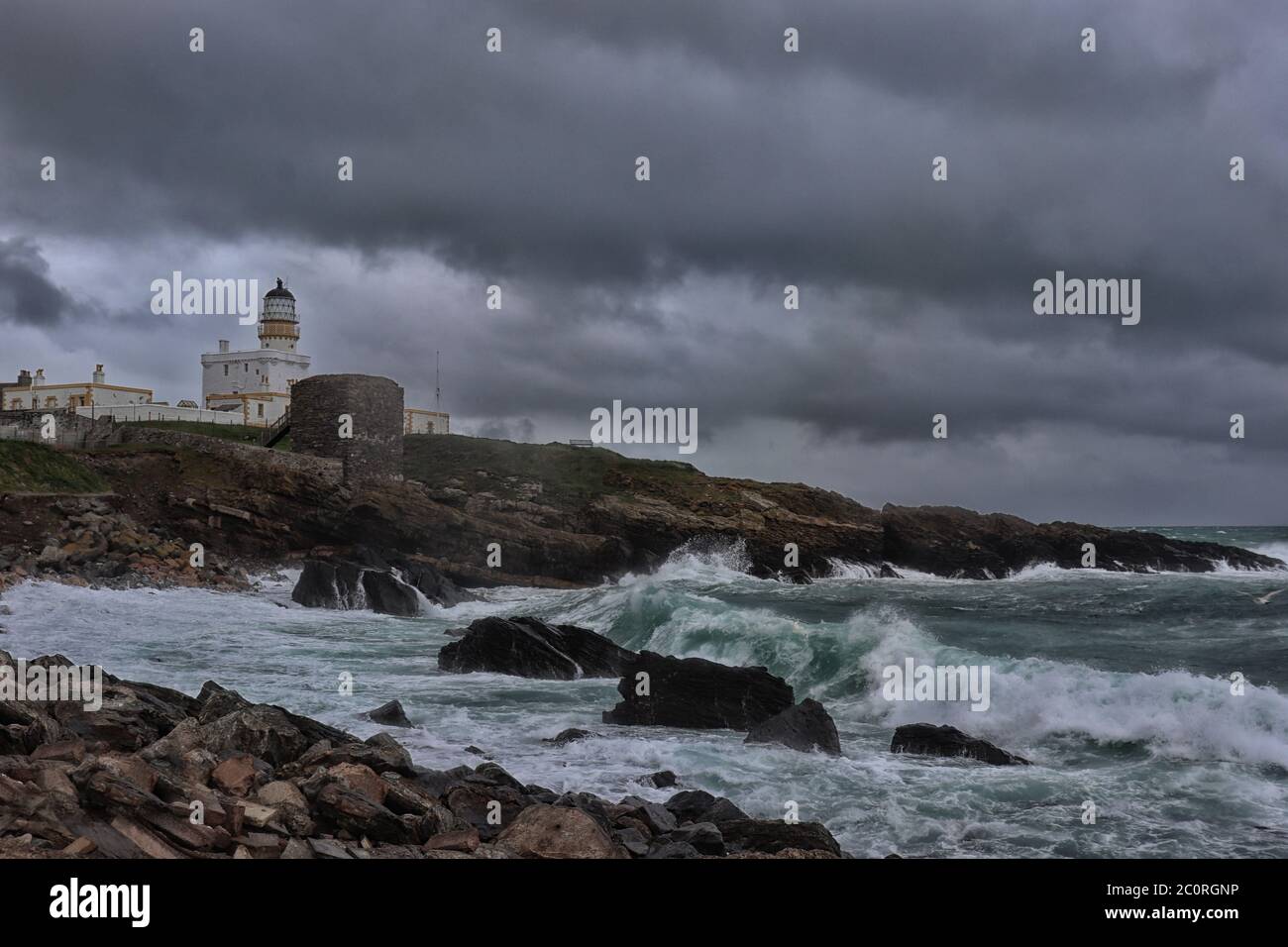 White lighthouse on rocks Stock Photo - Alamy