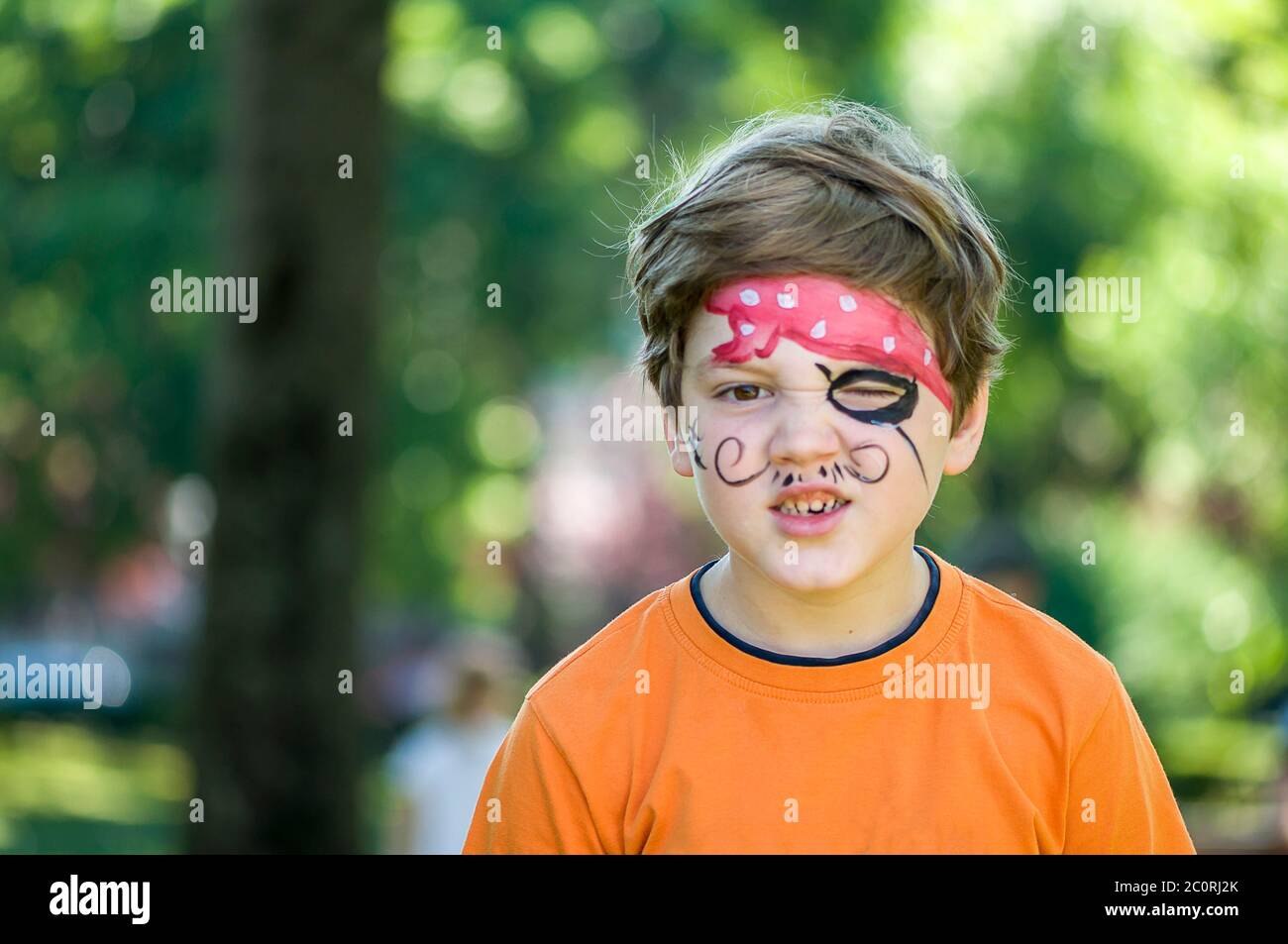 Child making funny faces. Kid with a pirate painting on his face Stock ...