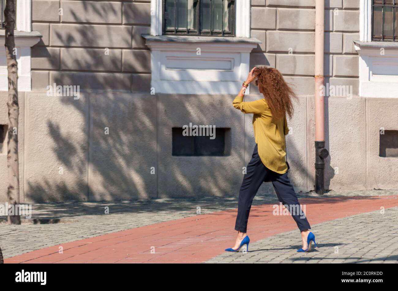 Woman walking on the street. Real people Stock Photo - Alamy