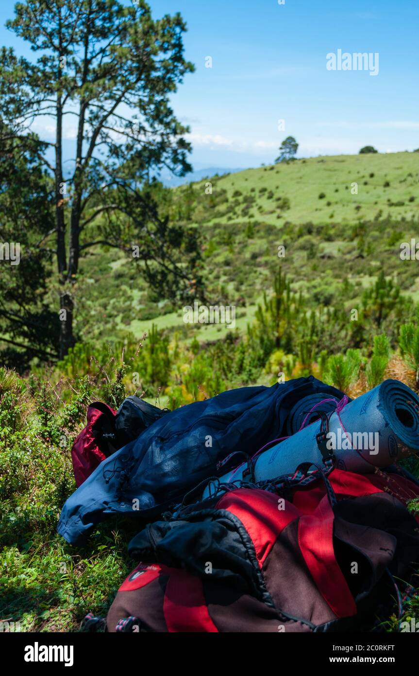 Backpack of a mountain hiker Laying on The Grass Stock Photo - Alamy