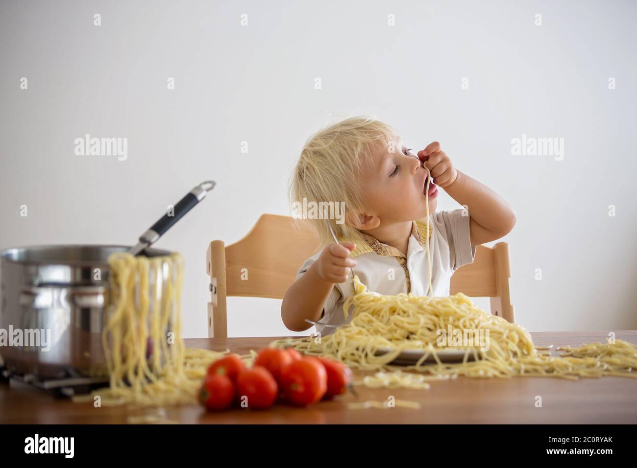 Little baby boy, toddler child, eating spaghetti for lunch and making a ...