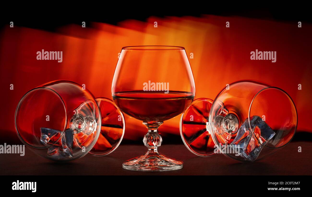 A glass of brandy on a red background Stock Photo - Alamy