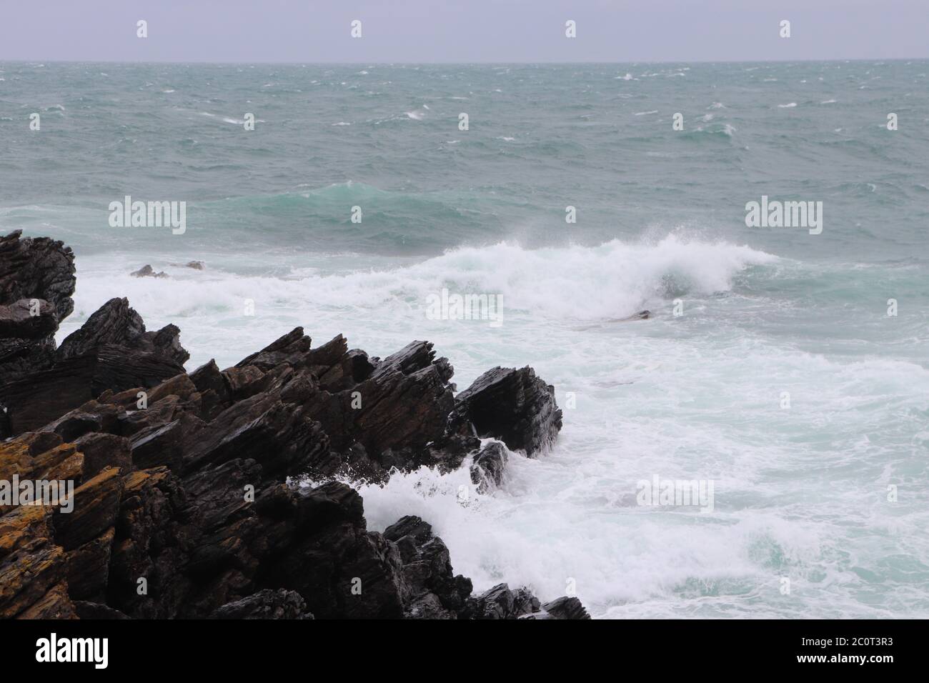 Rocks and stormy seas Stock Photo - Alamy