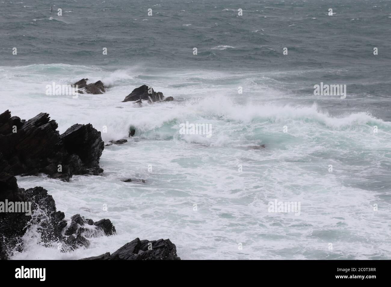 Rocks and stormy seas Stock Photo - Alamy
