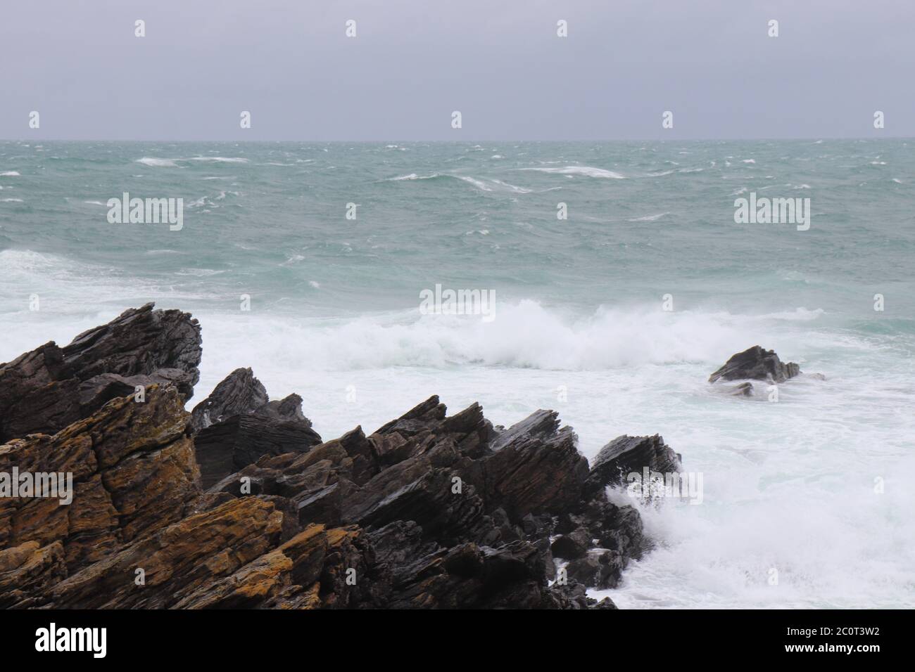 Rocks and stormy seas Stock Photo - Alamy