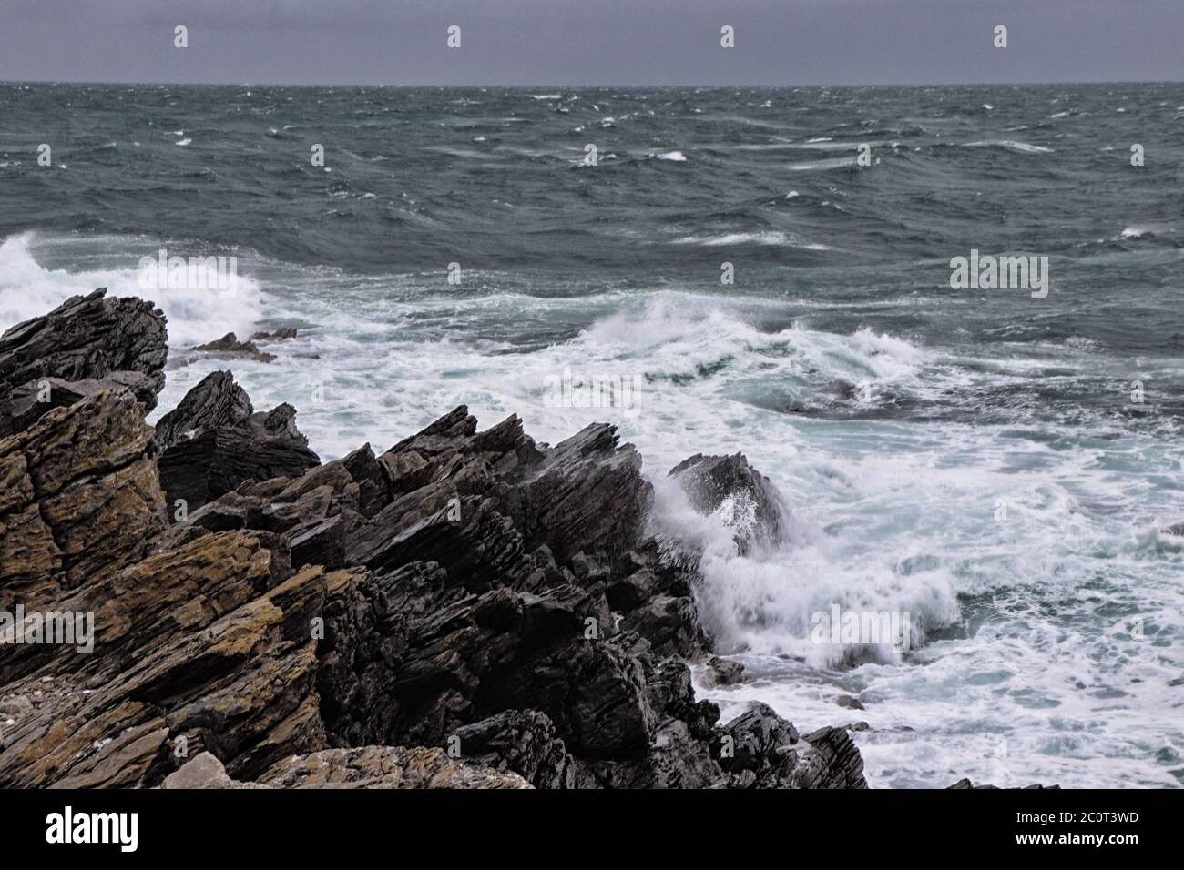 Rocks and stormy seas Stock Photo - Alamy