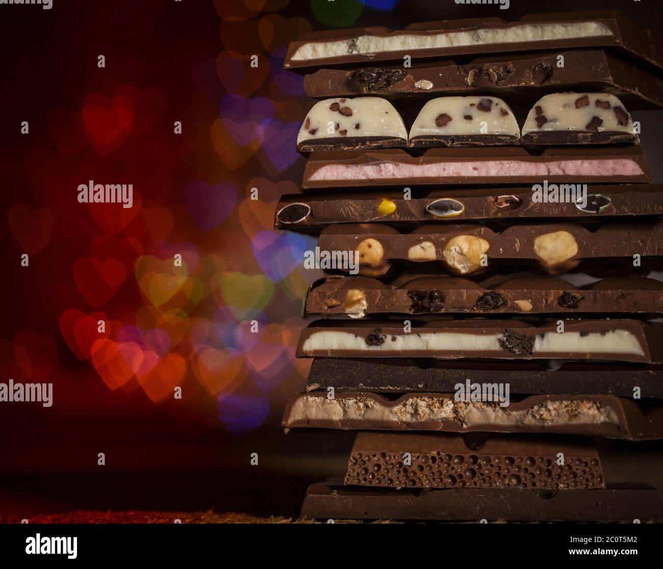 Chocolate stack on colorful bokeh background Stock Photo - Alamy