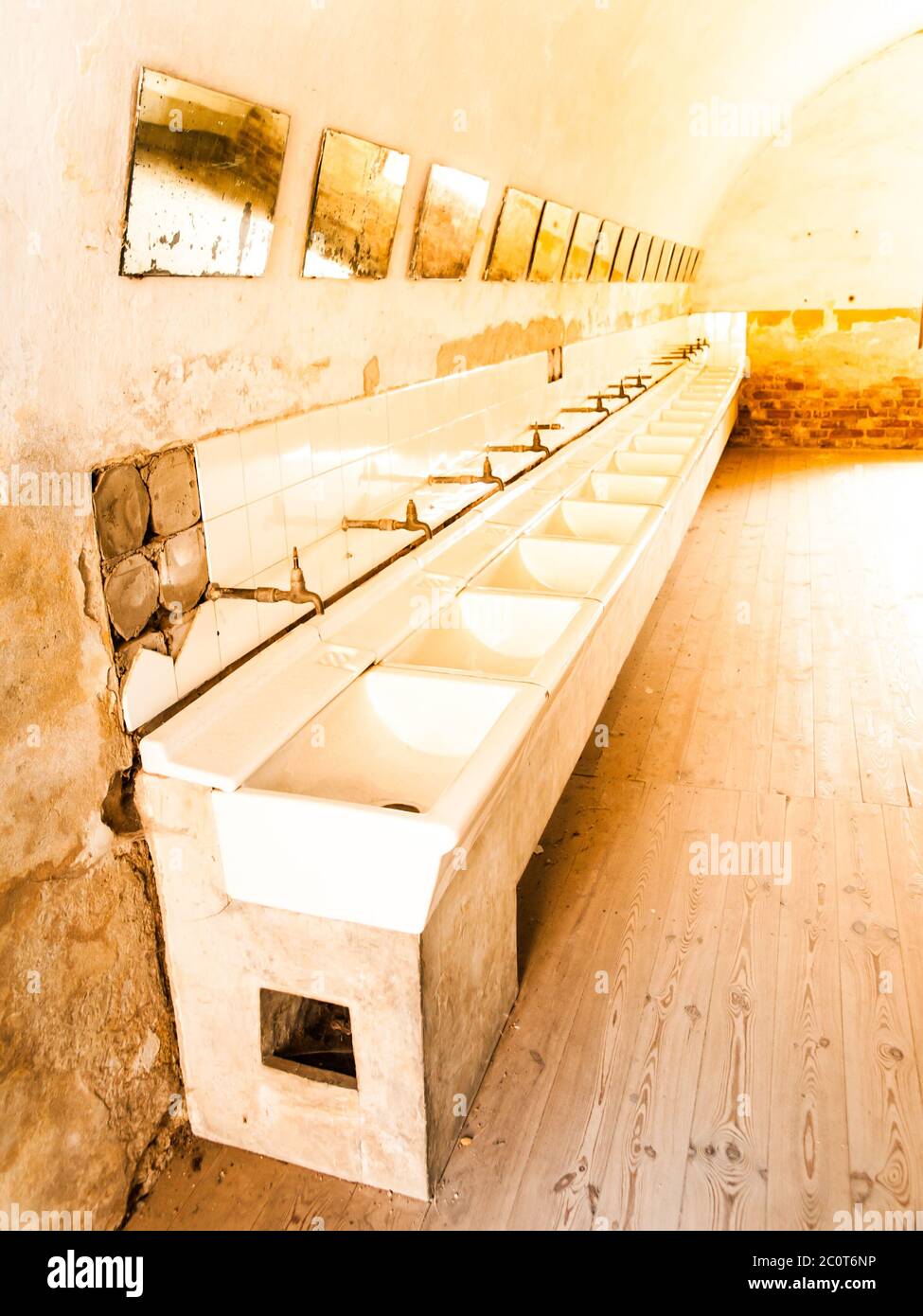 Row of sinks and mirrors in old prison bathroom, sepia image Stock ...