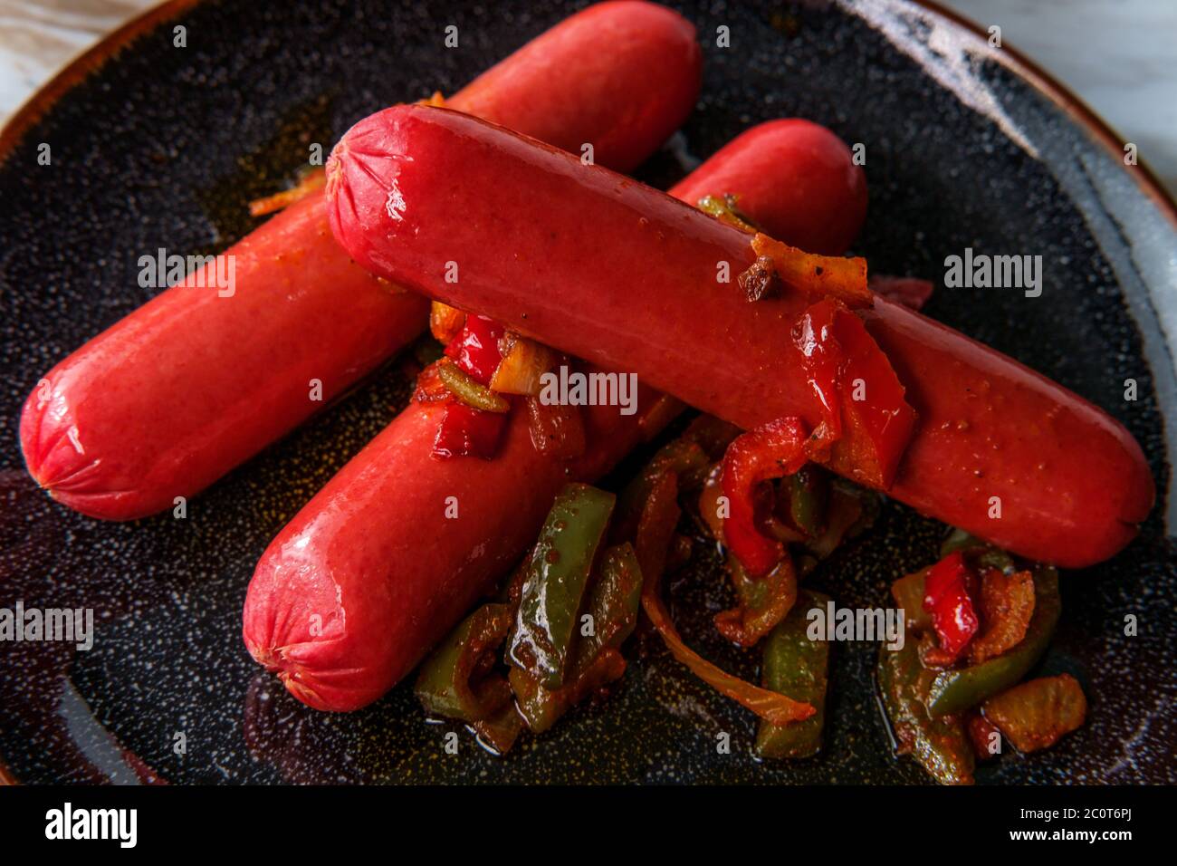 Hot spicy sausage with sliced peppers and onions Stock Photo - Alamy