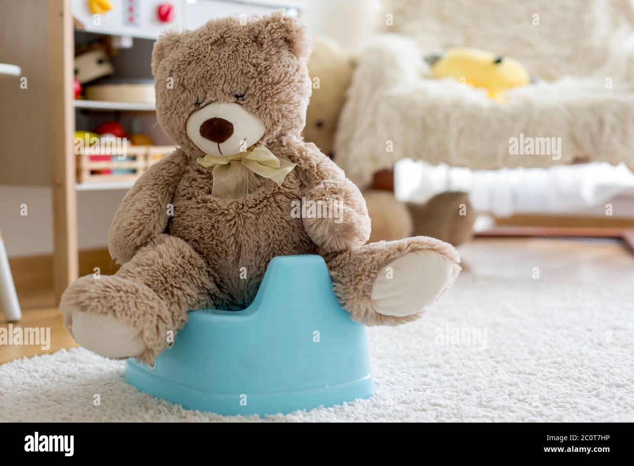 Cute toddler boy, potty training, playing with his teddy bear on potty ...