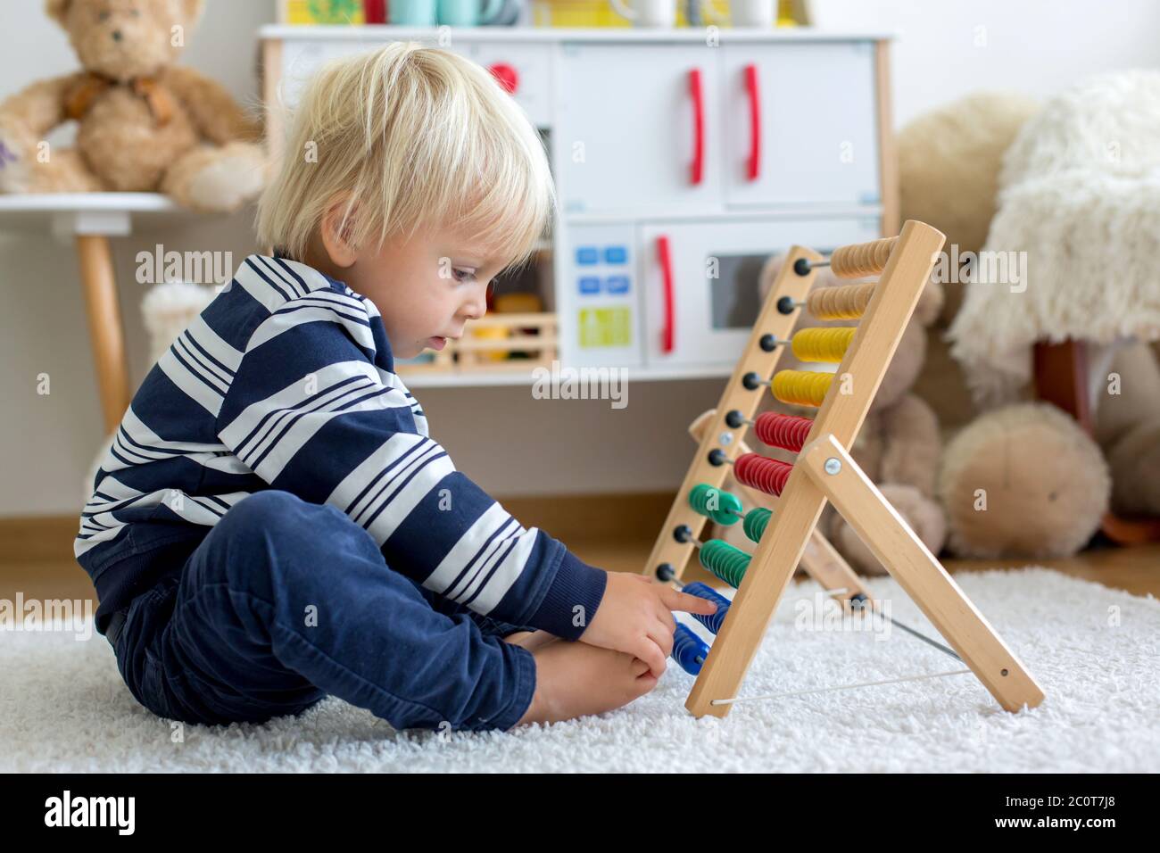 Cute toddler boy, playing with counter, colorful abacus, child learning ...