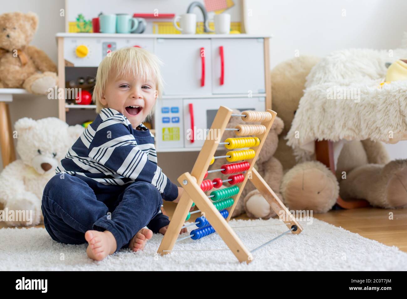 Cute toddler boy, playing with counter, colorful abacus, child learning ...