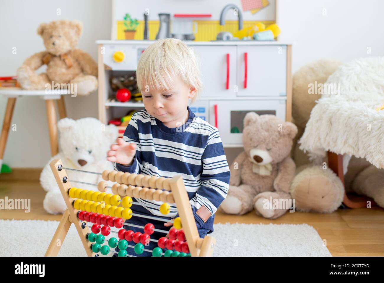 Cute toddler boy, playing with counter, colorful abacus, child learning ...