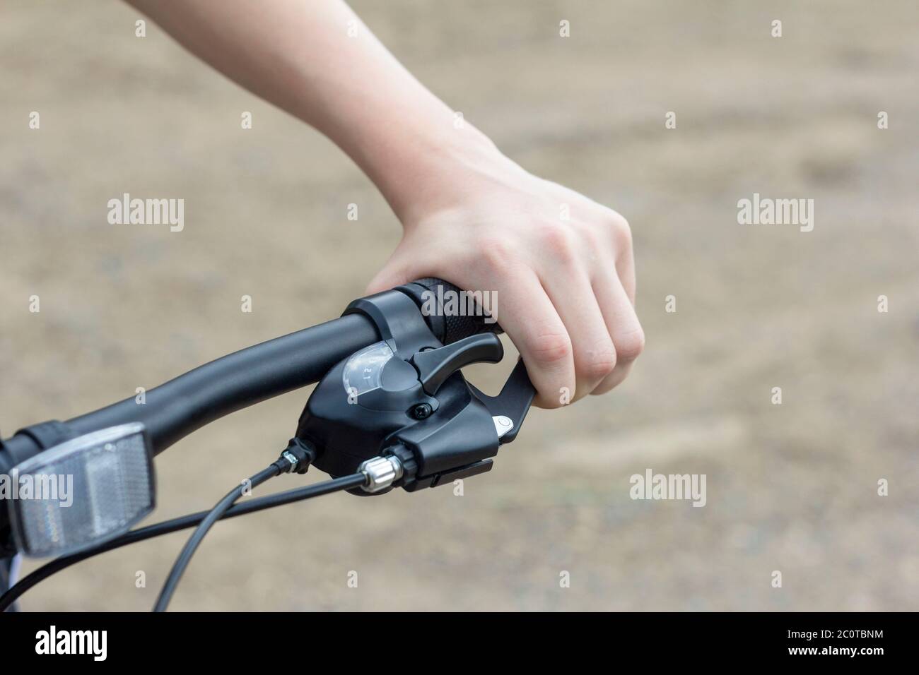 Close-up of a teenager's hands on the handlebars of a Bicycle Stock ...