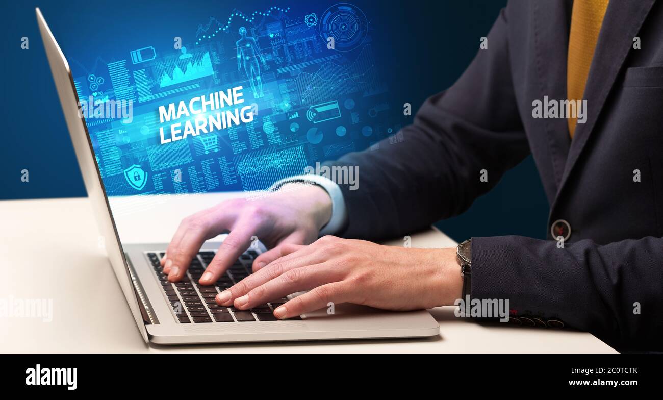 Businessman working on laptop with MACHINE LEARNING inscription, cyber ...