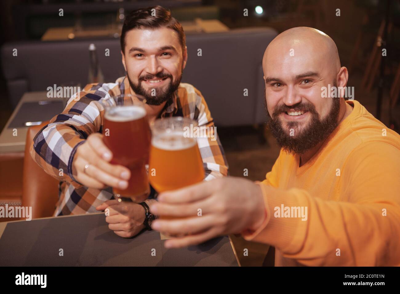 Two friends clink glasses hi-res stock photography and images - Alamy