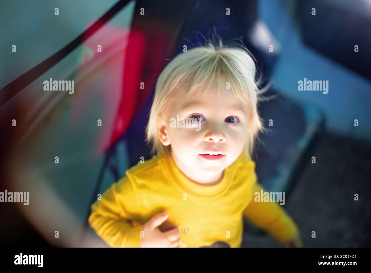 Little toddler boy in a space ship, illuminated control panel, child as ...