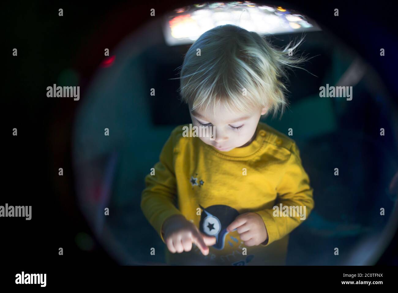 Little toddler boy in a space ship, illuminated control panel, child as ...