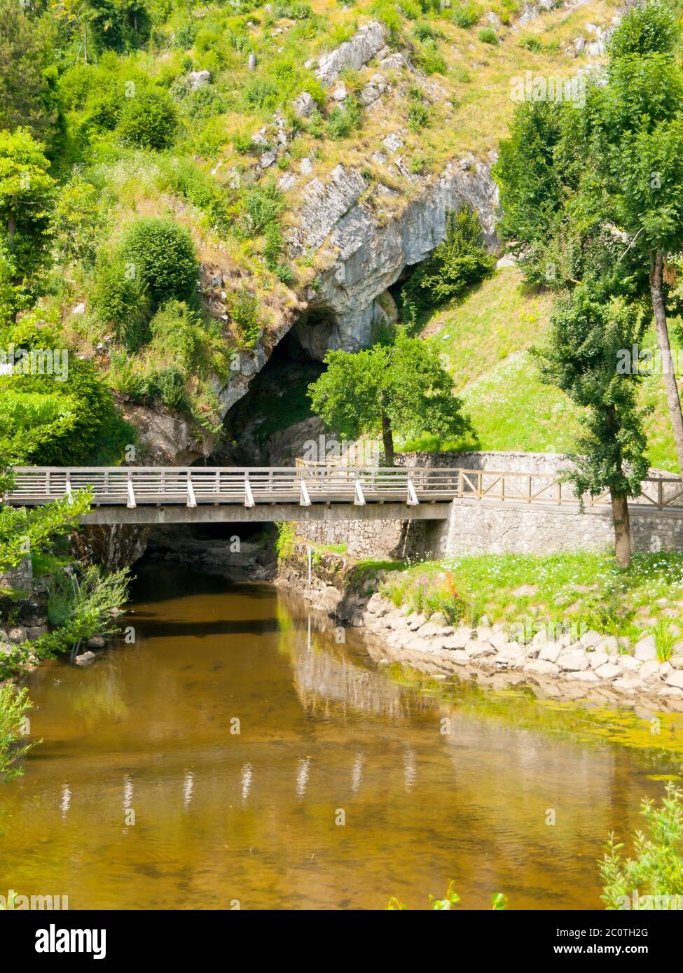 Pivka River swallow hole on with pedestrian bridge. Place where Pivka ...