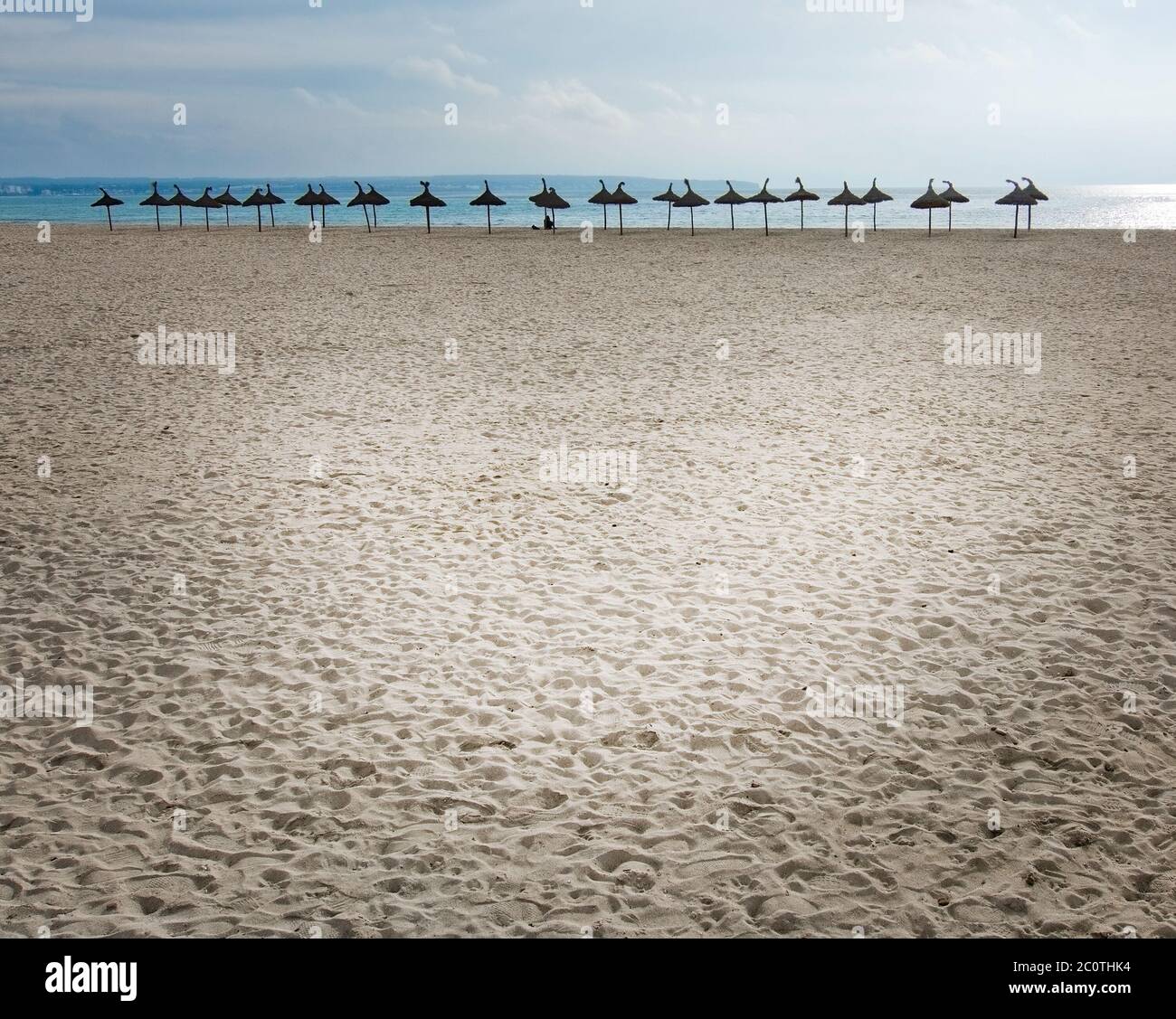 Parasols on vast empty winter beach with heart shaped spotlight Stock ...