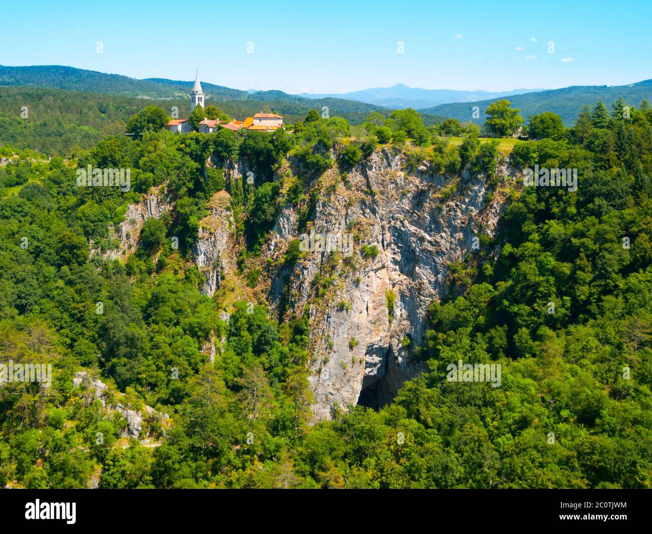 View of deep gorge of Reka River and village with rural church ,Skocjan ...