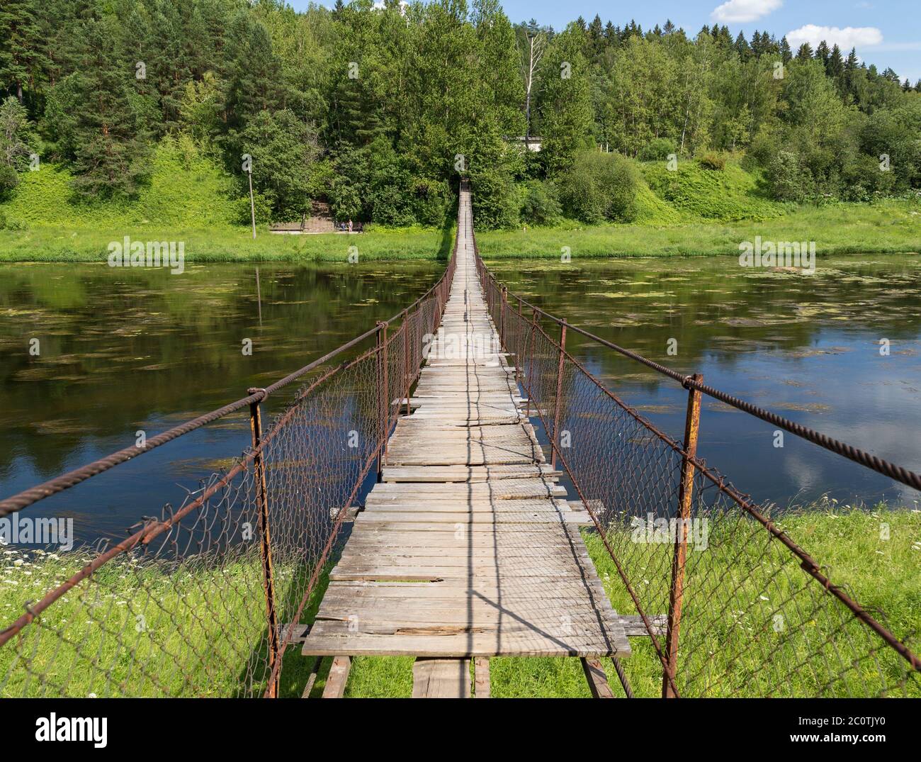 Hanging bridge goes over river Stock Photo - Alamy