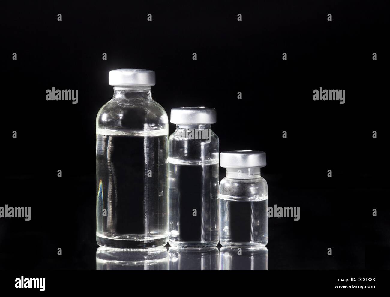 Glass Medicine Vials and Syringe on black background Stock Photo - Alamy