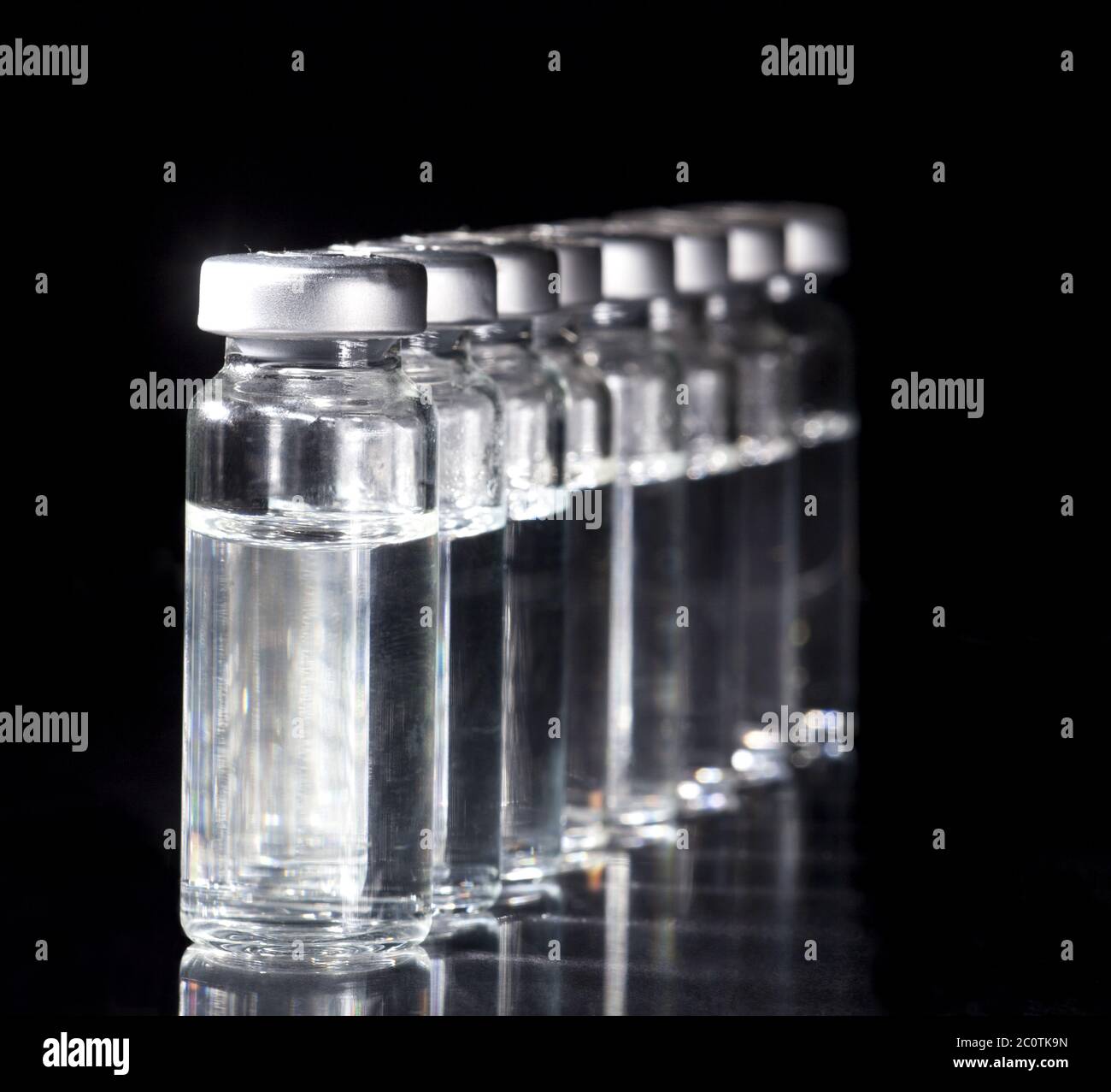 Glass Medicine Vials and Syringe on black background Stock Photo - Alamy