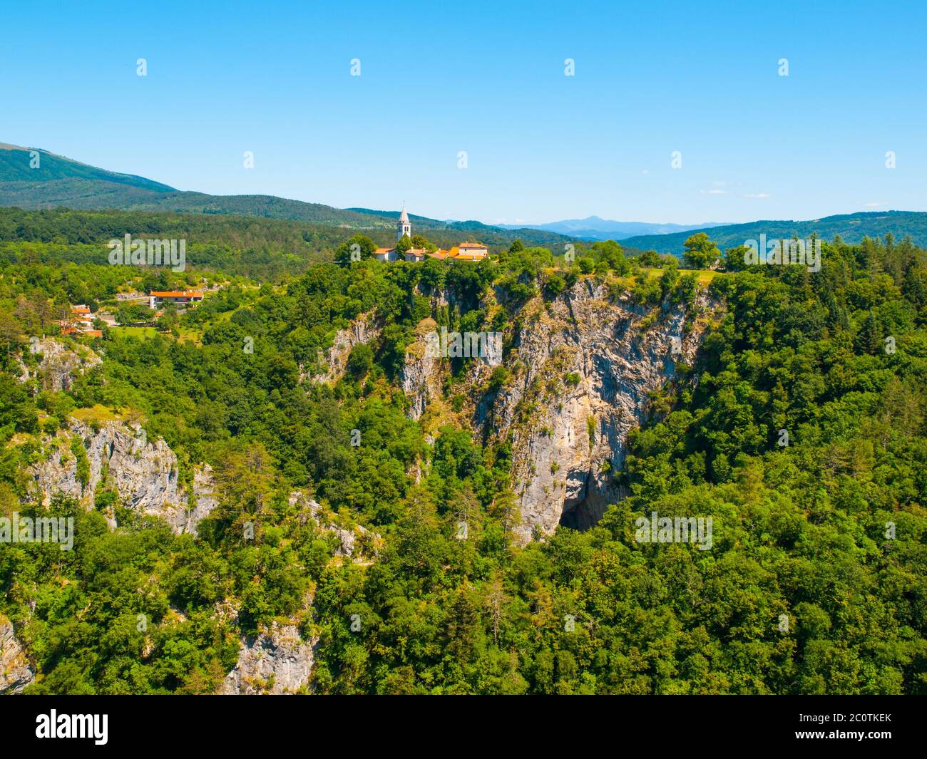 View of deep gorge of Reka River and village with rural church ,Skocjan ...