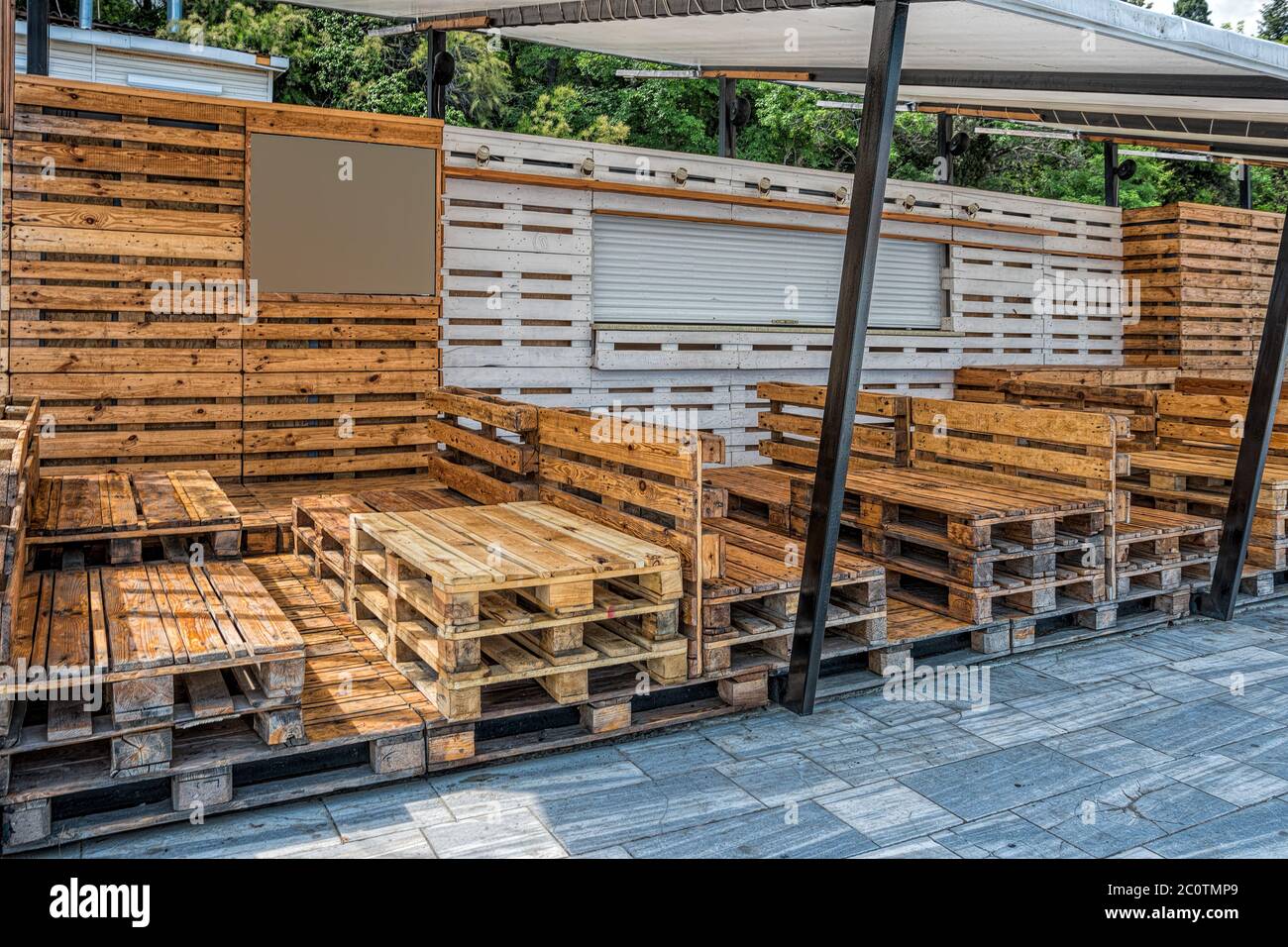 Wooden bench made of pallets of freight cargo cases for sitting ...