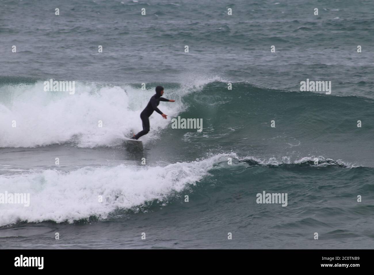 Lone surfer on stormy sea Stock Photo - Alamy
