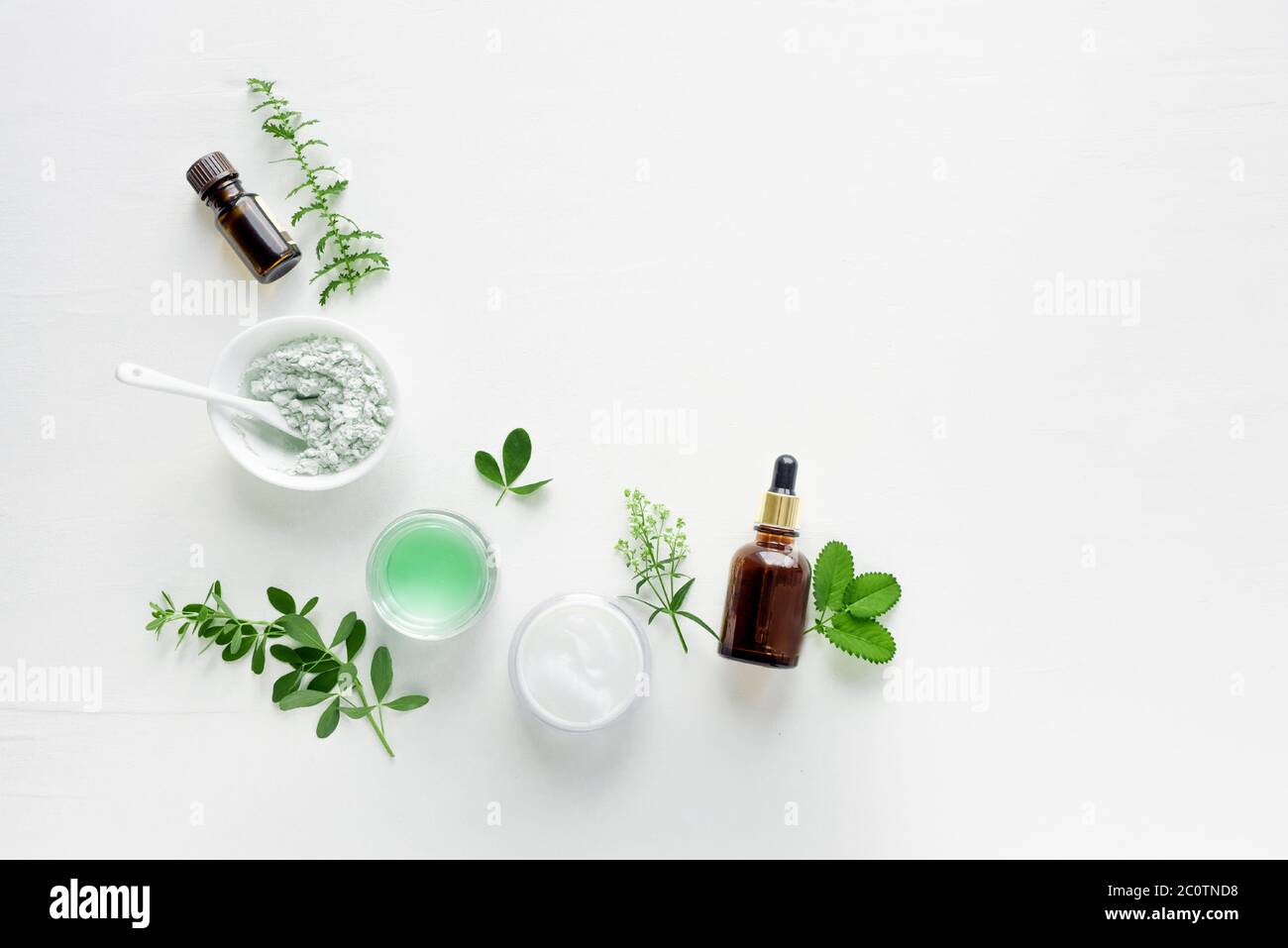Natural cosmetics and green leaves on white background, top view, copy ...