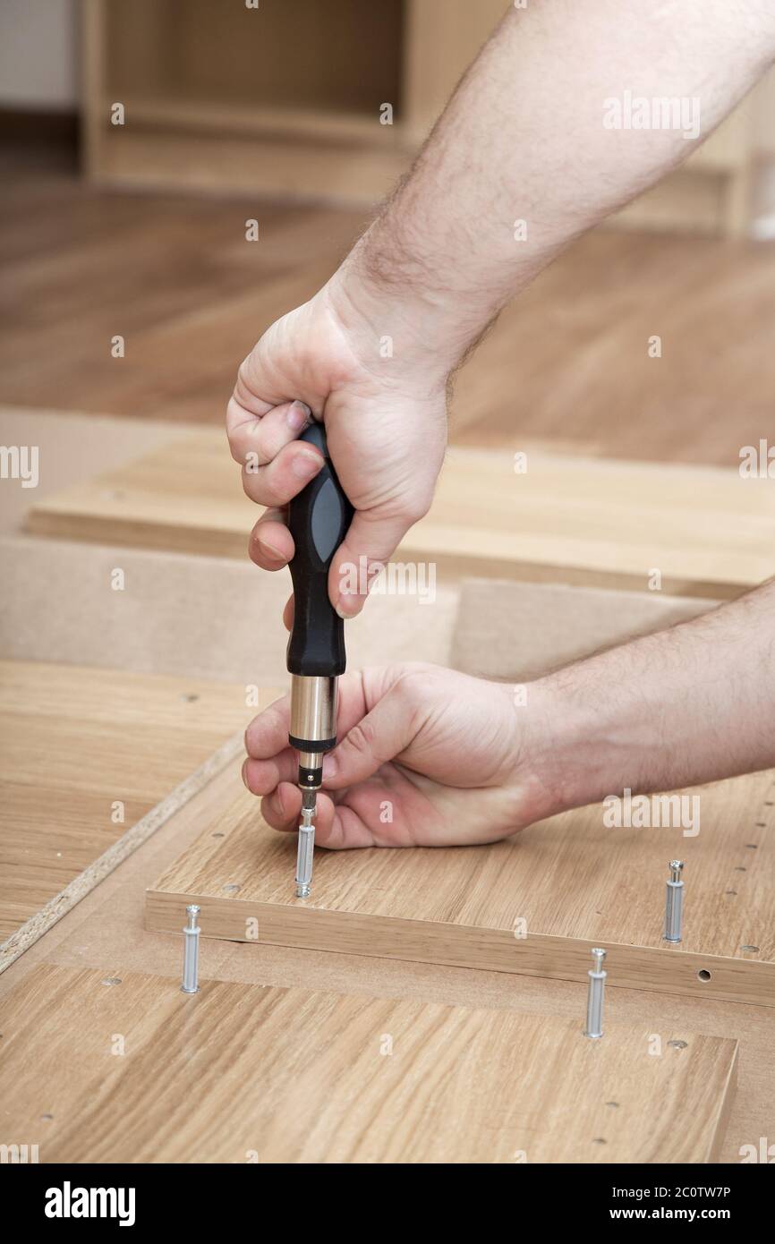 Close-up of man hands with a screwdriver Stock Photo - Alamy