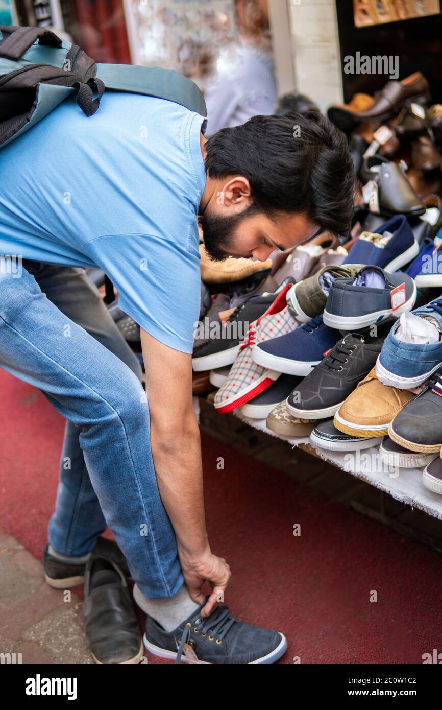 Indian man choosing and buying shoes form store at street market Stock ...