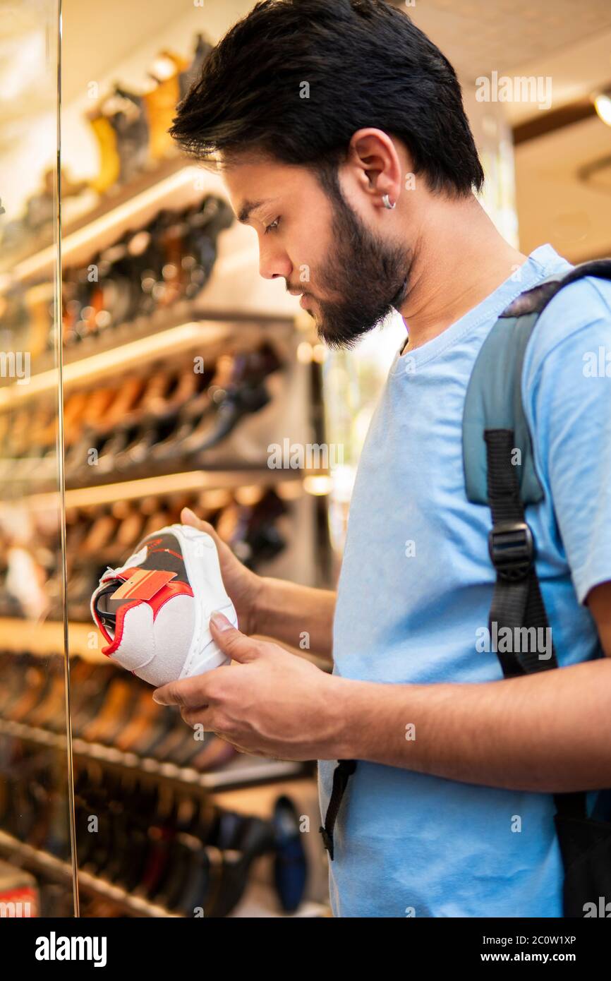 Indian man choosing and buying shoes form store at street market Stock ...