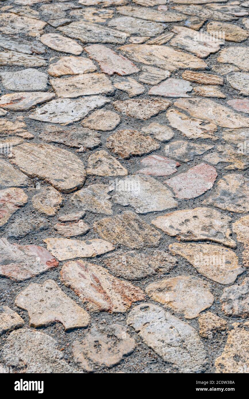 The road paved from wild paving stones of various shapes. Wild stone ...