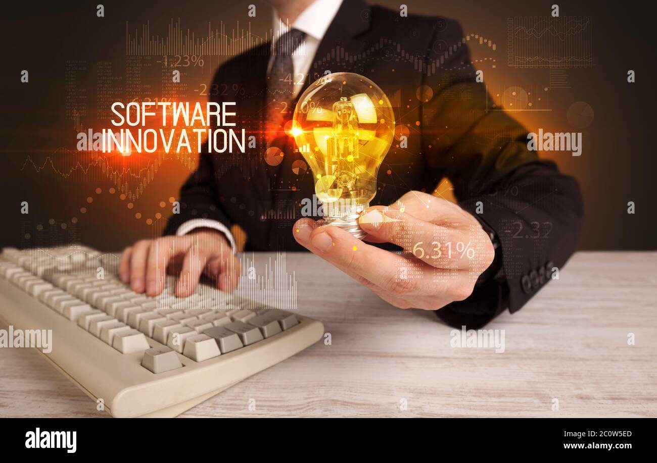 Businessman holding lightbulb with SOFTWARE INNOVATION inscription, Business technology concept ...