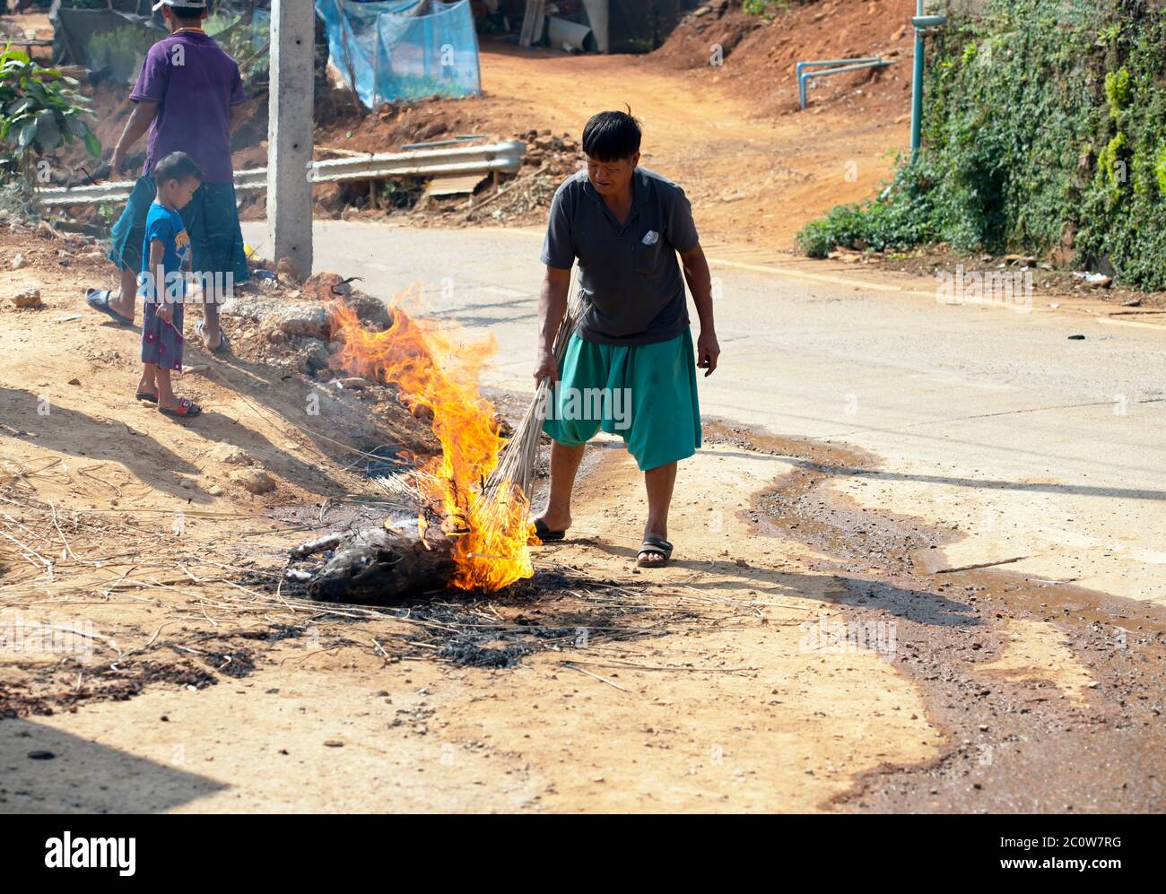 After slaughtering a pig in an indigenous, ethnic Lisu village, its ...