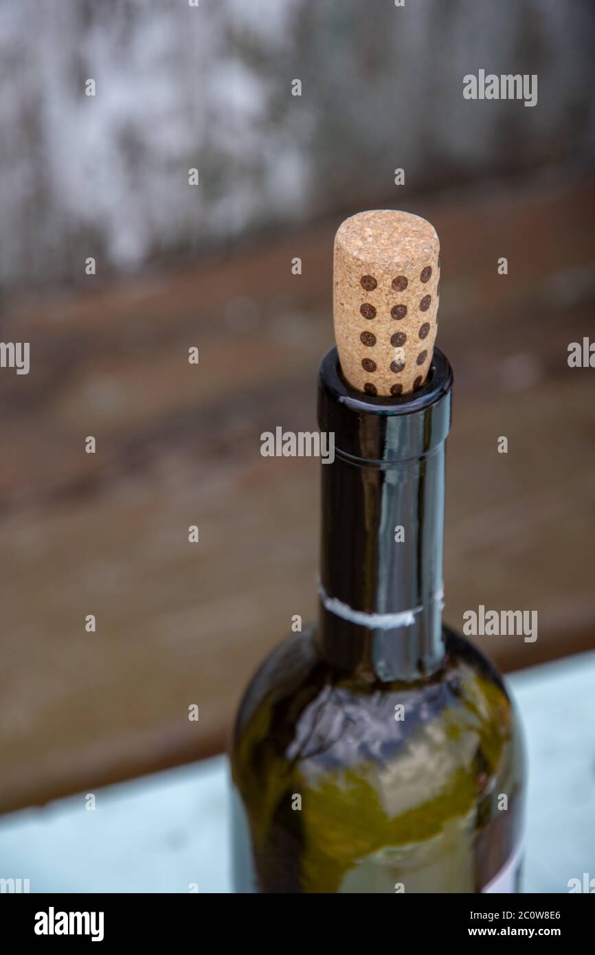 Dots on wine cork of glass bottle on rustic wooden blurred background ...
