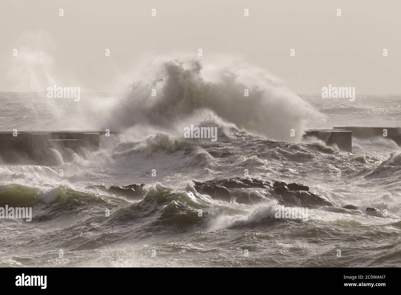 Big wave splash against pier and beacon Stock Photo - Alamy