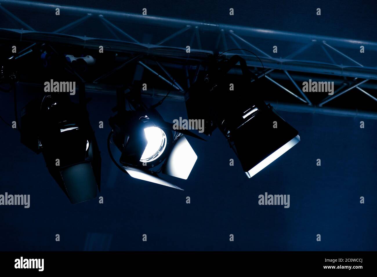 three spotlights at a cross bar Stock Photo - Alamy