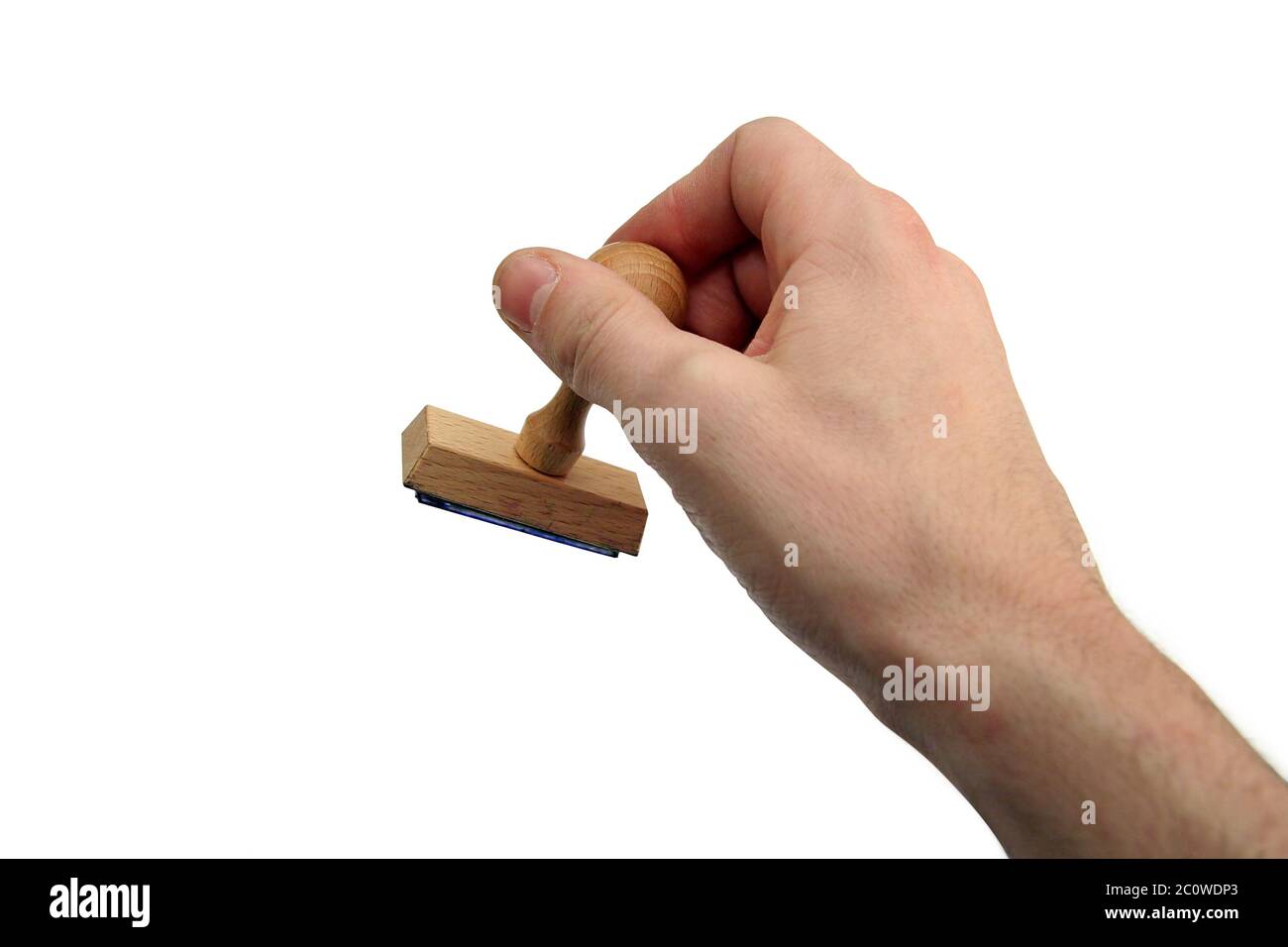 man hand holding a wooden stamp. white background Stock Photo - Alamy